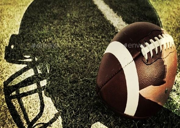 Shadow of a football player over a football on the football field ...