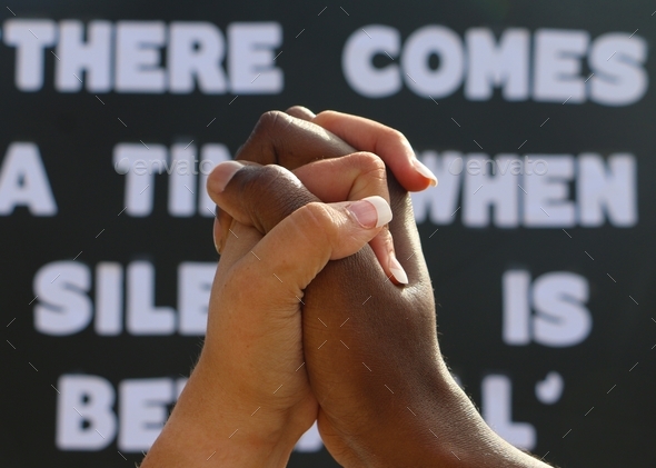 Stronger Together: Image of Caucasian and African American hand locked ...