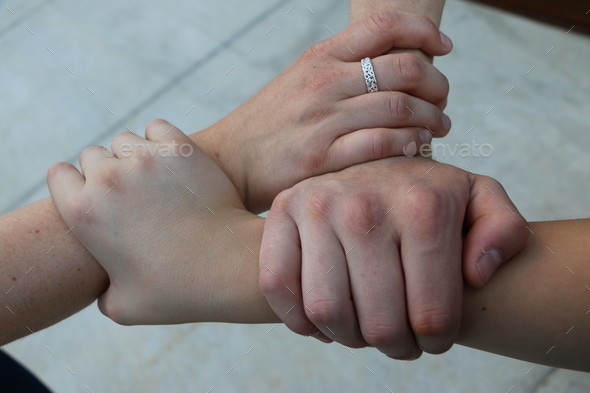 Support Trifecta: Three siblings locking arms around the wrists making ...