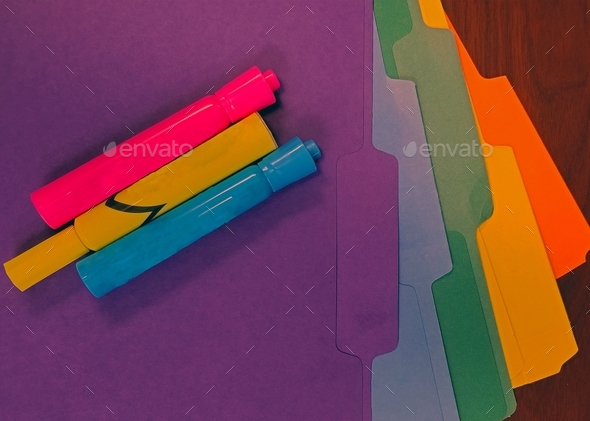 Background image of bright colored filing folders and highlighting ...