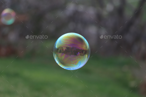 Closeup image of light capturing effervescent colors of single bubble ...