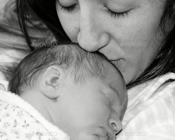 Monochromatic image of exhausted new mom falling asleep with newborn ...