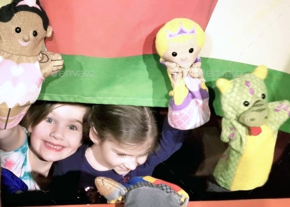 Little girls having fun playing with hand puppets. Kids having fun ...