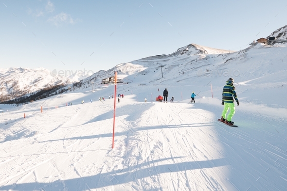 Skiing on the ski slope over italian alps Stock Photo by rattodisabina