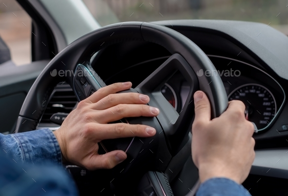 Left male hand honking the car horn, man driving vehicle and beeping ...