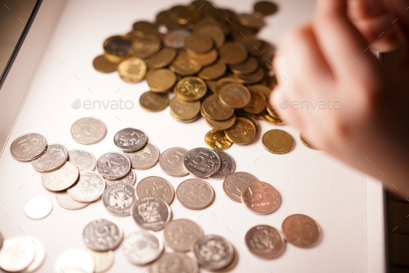 Cointing money, in search of a rare coin Stock Photo by vinokurovyury
