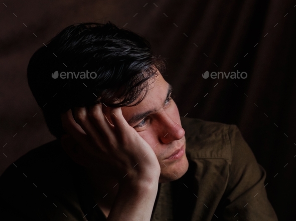 Serious sad young man thinking about problem. Depression and anxiety ...