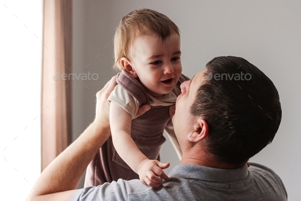 Dad hugs the child with tenderness and love Stock Photo by ElenNika