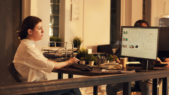Office worker analyzing diagrams and charts on computer Stock Photo by ...