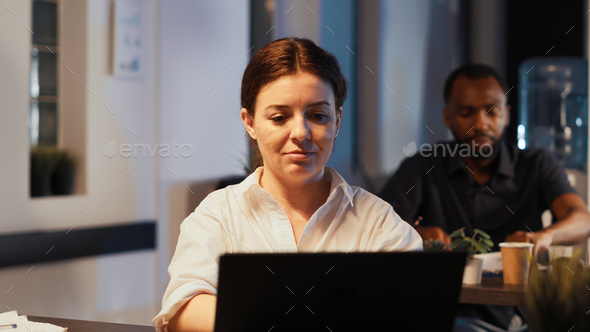 Startup employee working on corporate project at night Stock Photo by ...