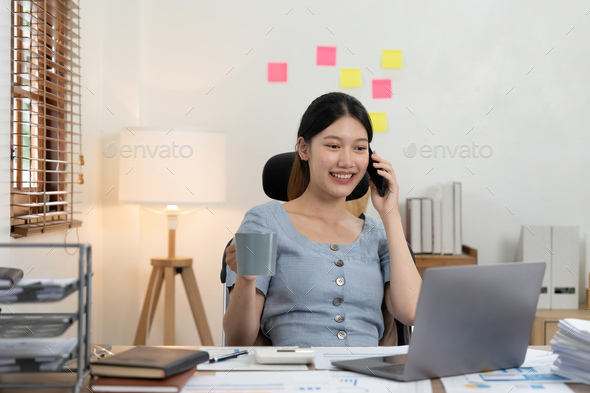 Young accountant with smartphone to call marketing consultants and ...