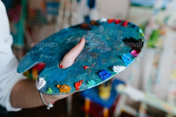 Female hand holding artist's palette with oil paints. Stock Photo by ...