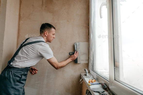 Worker applying putty mortar on the balcony wall Stock Photo by ...