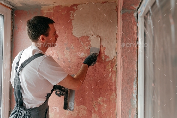Worker applying putty mortar on the balcony wall Stock Photo by ...