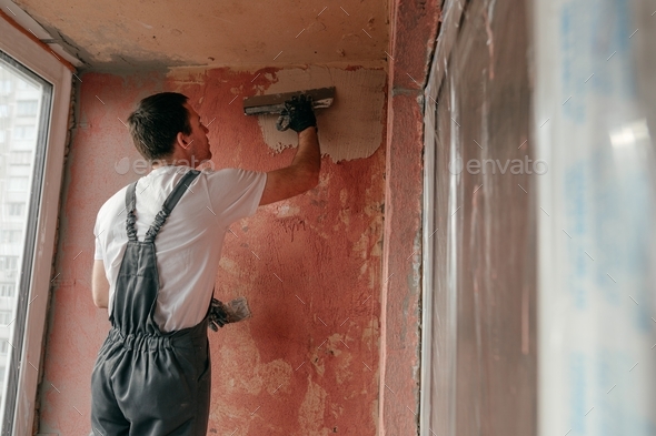 Worker applying putty mortar on the balcony wall Stock Photo by ...