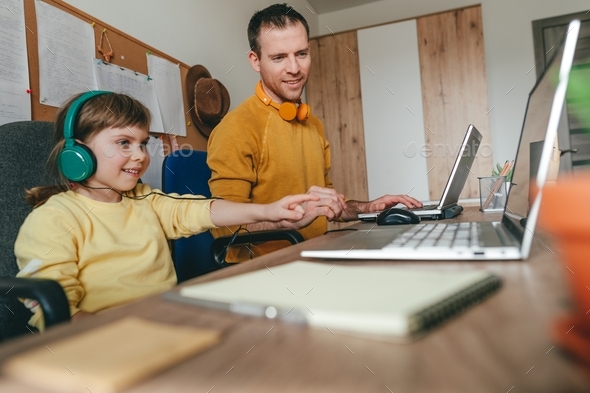 Little girl with her father using technology at home Stock Photo by ...