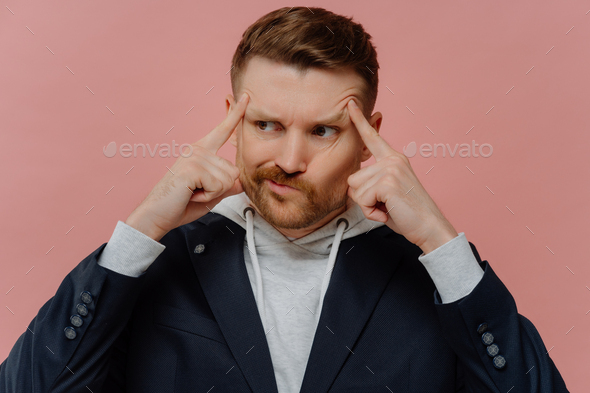 Man having doubts and making decision isolated over pink wall Stock ...