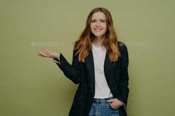 Pretty young female with tipping hand expressing confusion Stock Photo ...