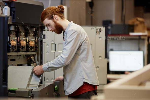 Man Using Printing Machine Stock Photo by seventyfourimages | PhotoDune
