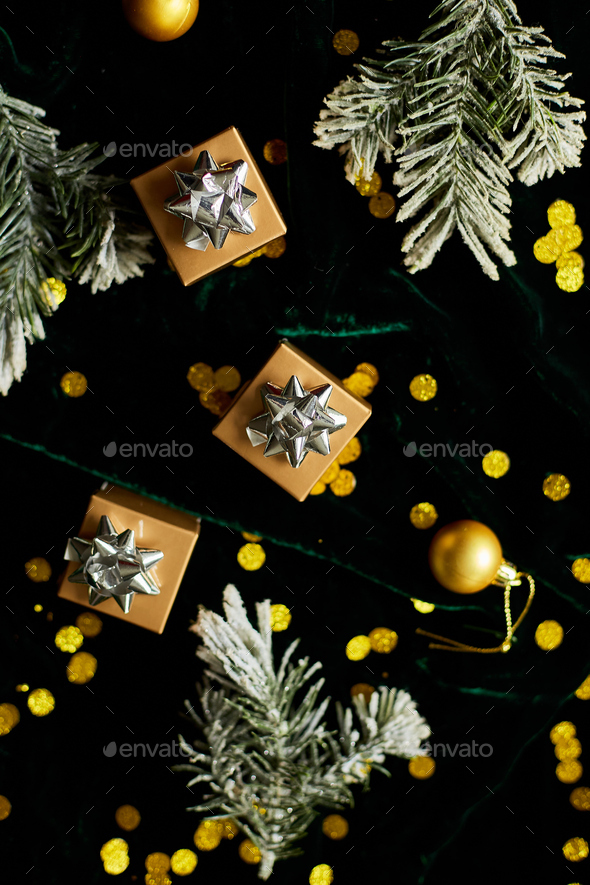 Gold gift boxes with silver ribbon on shine velur green background ...