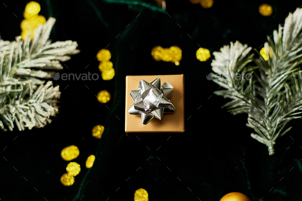 Gold gift boxes with silver ribbon on shine velur green background ...