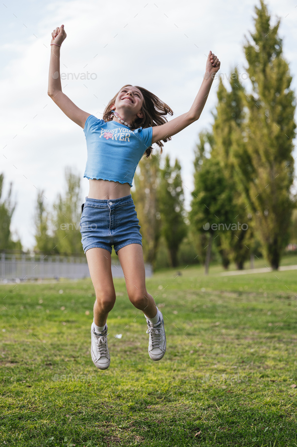 The very happy girl jumping in nature. Stock Photo by karrastock ...