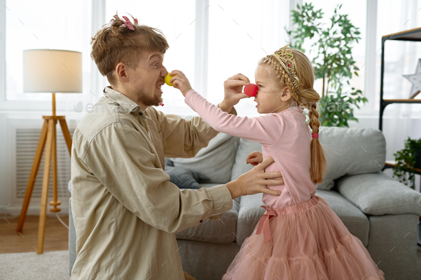 Dad and daughter wearing clown nose having fun Stock Photo by NomadSoul1