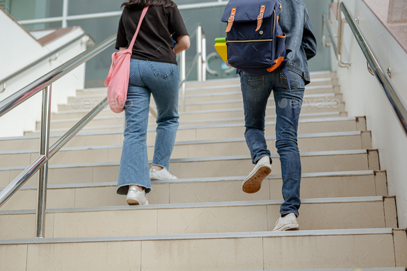 Students are walking up the stairs to the classroom.Teenager in campus ...