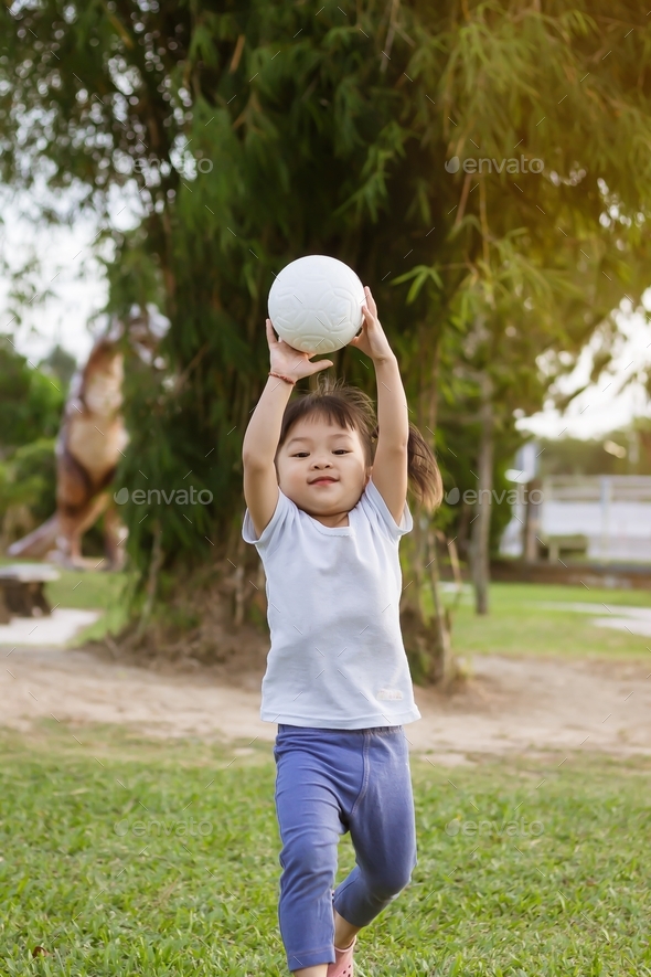 toddler baby girl. Happy Asian child playing with the toy at the park ...
