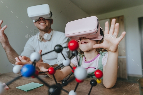 Little girl having fun time with her father using VR glasses Stock ...