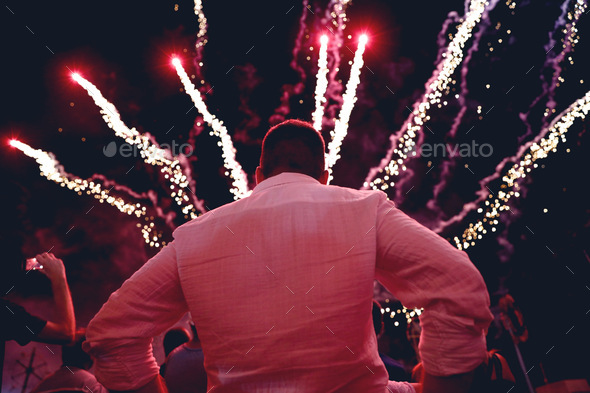 Celebrations around the world. A man from behind looking at the ...