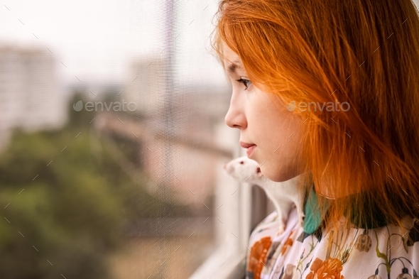 Ginger girl with white rat looking through the window Stock Photo by ...