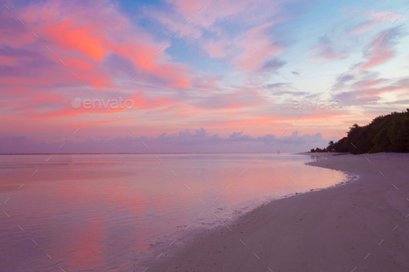 Pink sunset at the beach in Maldives in summer Stock Photo by takemewu31