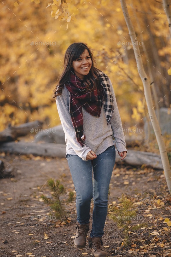 A millennial Hispanic girl laughing and having a good time outdoors ...