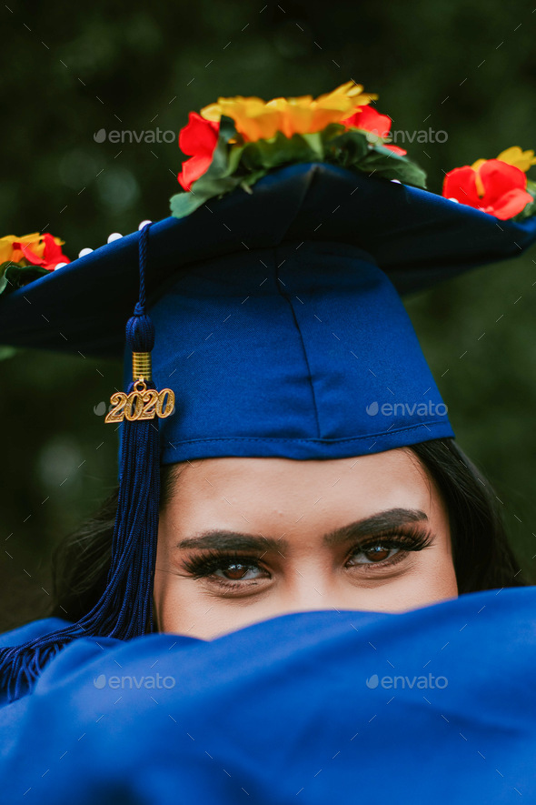 2020 beautiful young graduate wearing blue cap and gown covering her ...
