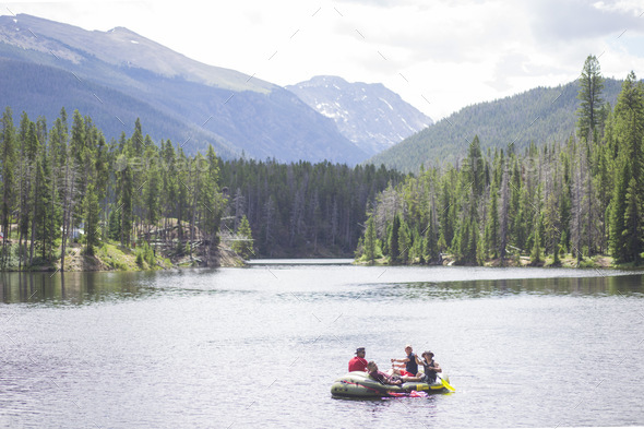 A group of friends having fun at the lake and fishing in a boat Stock ...