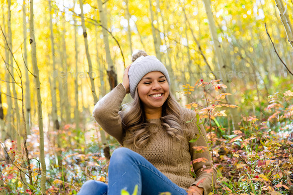 Woman laughing enjoying a good time in a forest full of Aspen trees in ...