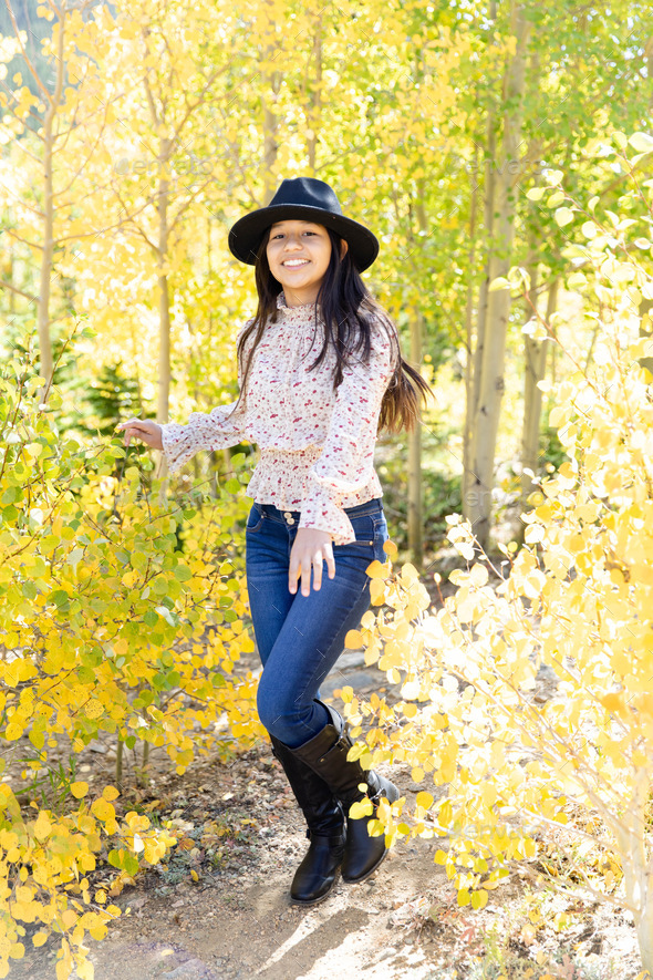 Young girl surrounded by aspen trees during fall dancing Stock Photo by ...