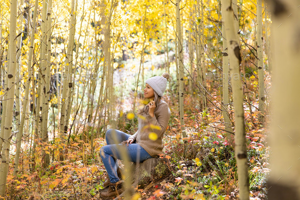 Woman in the wilderness in the middle of aspen trees during fall Stock Photo by takemewu31
