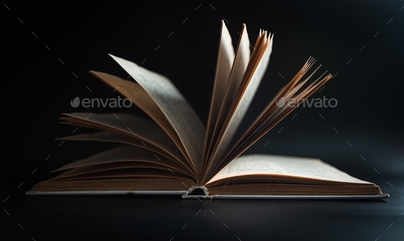 Open book with pages on a black background. Stock Photo by rstavila1