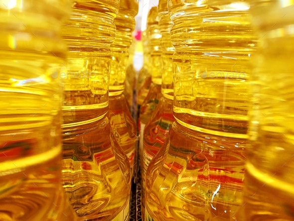View Between Bottles of Golden Cooking Oil Stock Photo by akedynamic