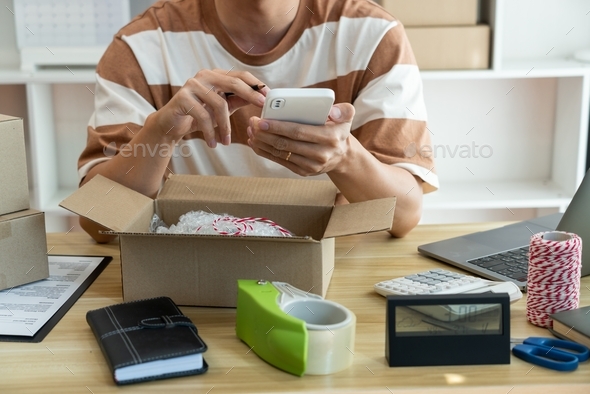 the commercial agent using his smartphone to check clients’ information ...