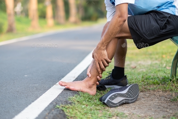 man holding his sports leg injury. muscle painful during training ...