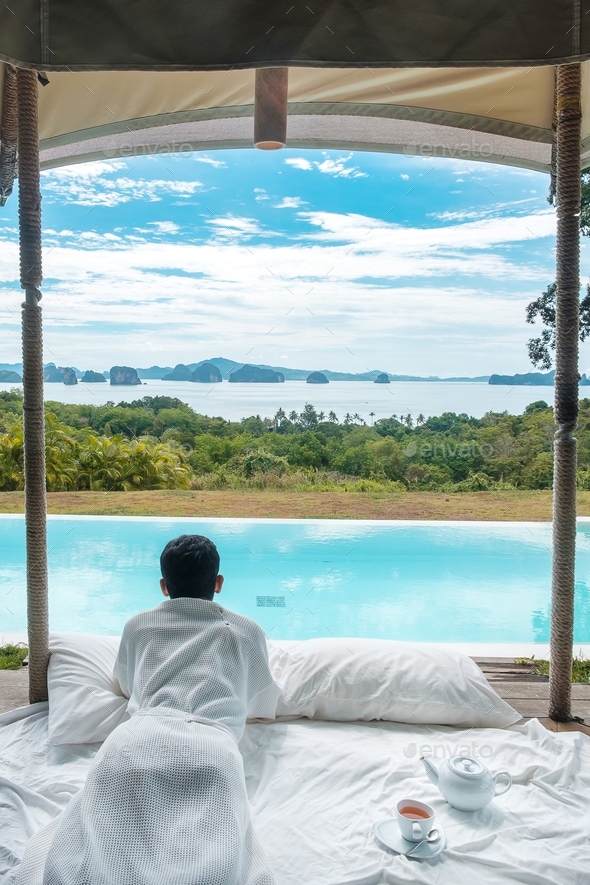 Man traveler enjoy ocean view, Tourist relaxing in tropical luxury ...