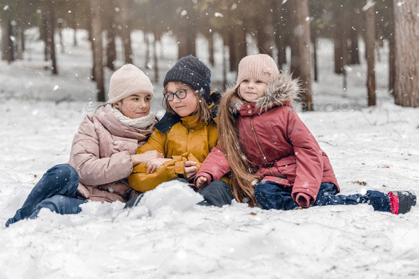 Kids playing in snow. Children play outdoors in winter snowfall. Stock ...