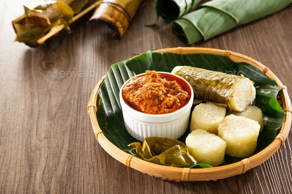 Lemang. Glutinous rice is wrapped with lerek or banana leaf encased in ...