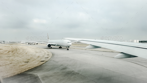 Planes lined up on a busy runway, preparing for take off Stock Photo by ...