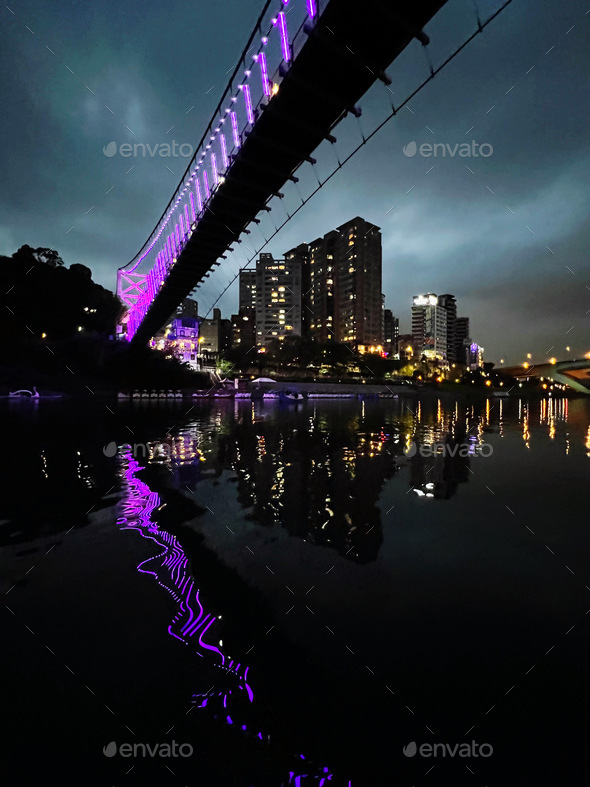 Reflection of Illuminated suspension bridge Stock Photo by MayFayStudio