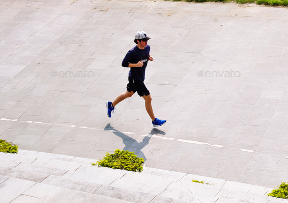 Teenager juggling in a sunny day with shadow on the ground Stock Photo ...