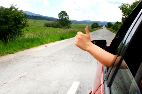 Hand outside the car wndow on the road Stock Photo by mirarahneva ...